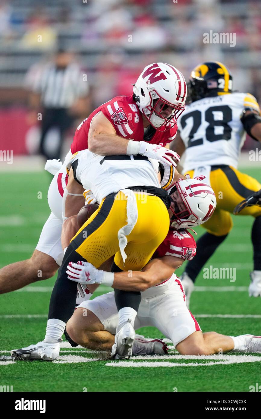 Wisconsin safety Charlie Jarvis (34) and safety Grant Dean (16) tackle ...
