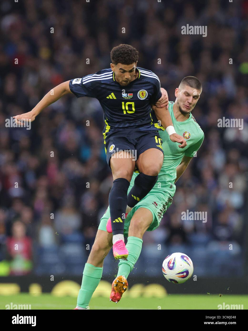 Scotland's Che Adams (left) and Belarus' Egor Parkhomenko (right) battle for the ball during the ...