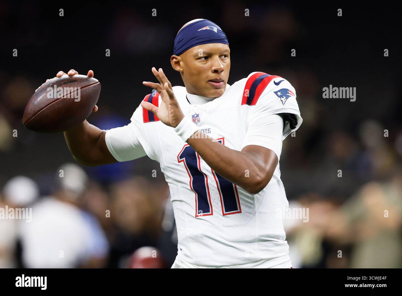 New England Patriots quarterback Josh Dobbs warms up before an NFL ...