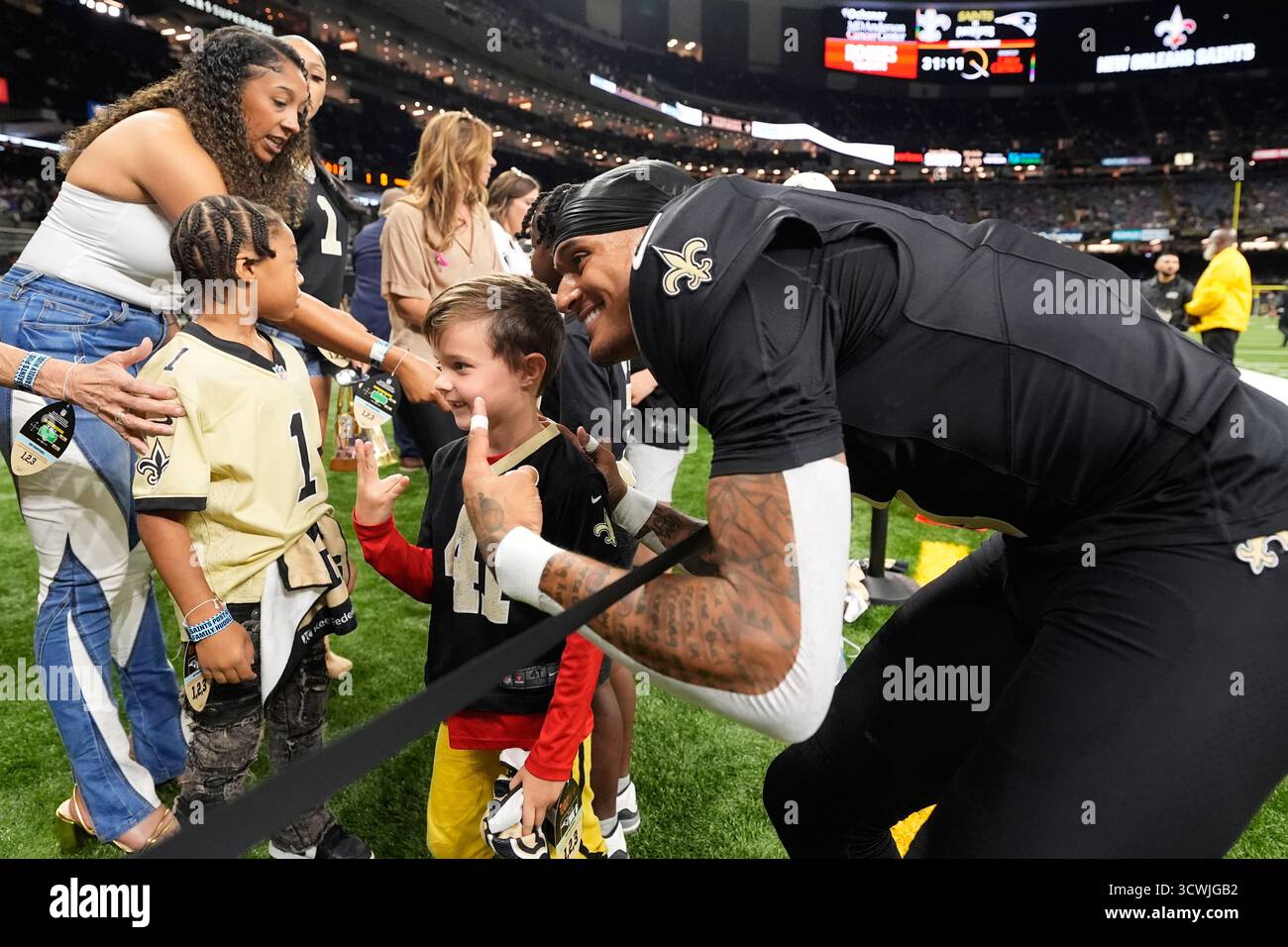New Orleans Saints cornerback Alontae Taylor, right, poses with fans ...