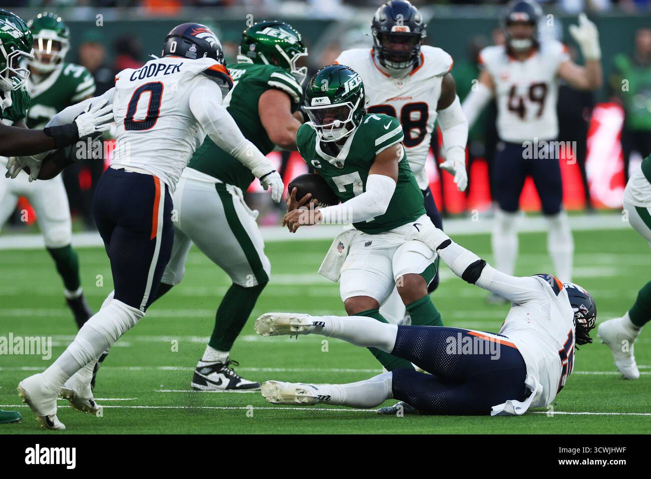 New York Jets quarterback Justin Fields, center, is sacked by Denver ...