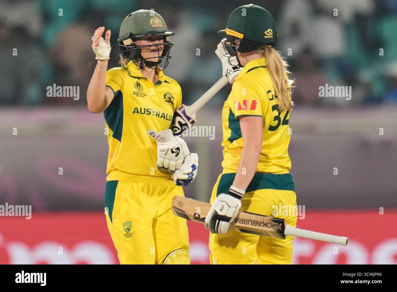 Australia's Ellyse Perry, left, and batting partner Kim Garth celebrate ...