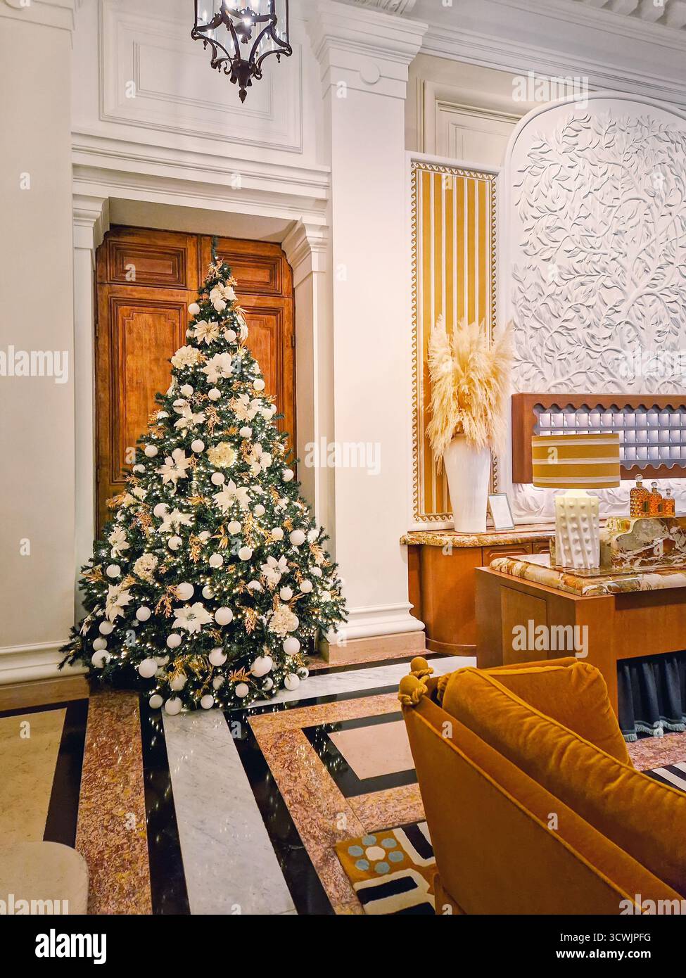 A lavish hotel lobby decorated for winter holidays, with a tall ...