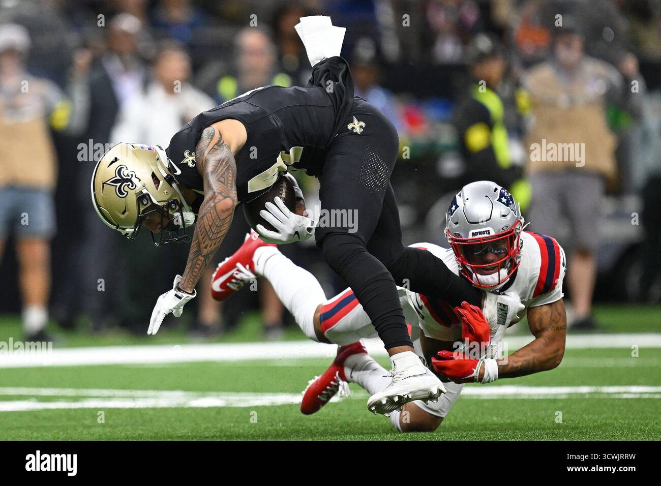 New Orleans Saints wide receiver Devaughn Vele, left, is tackled by New ...