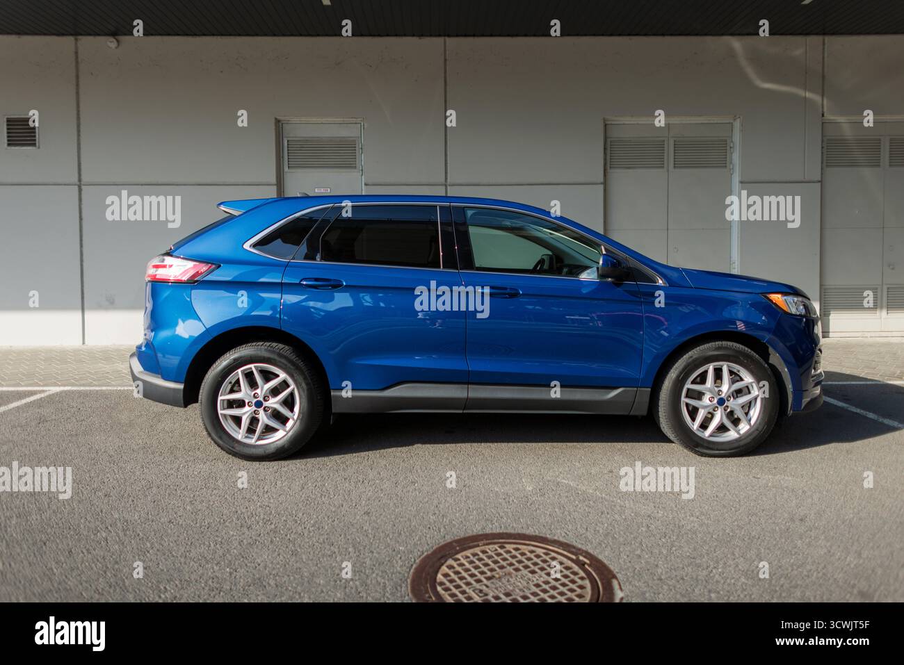 Blue SUV Car Parked Outdoors Near Modern Building Wall. Side View Of ...