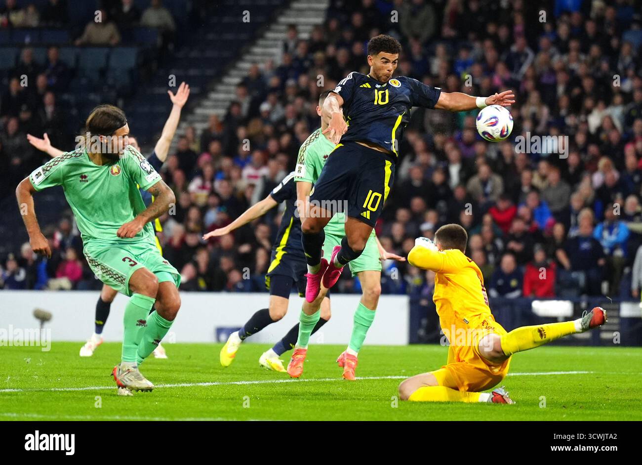Scotland's Che Adams (centre) scores a goal before being ruled out for ...