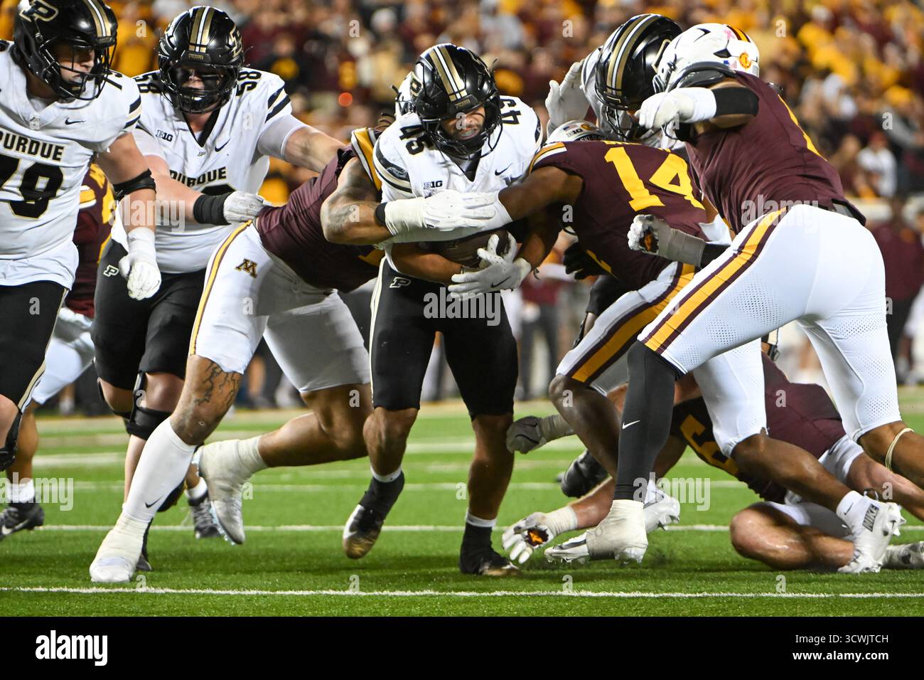 Purdue running back Devin Mockobee (45) is stopped by Minnesota ...