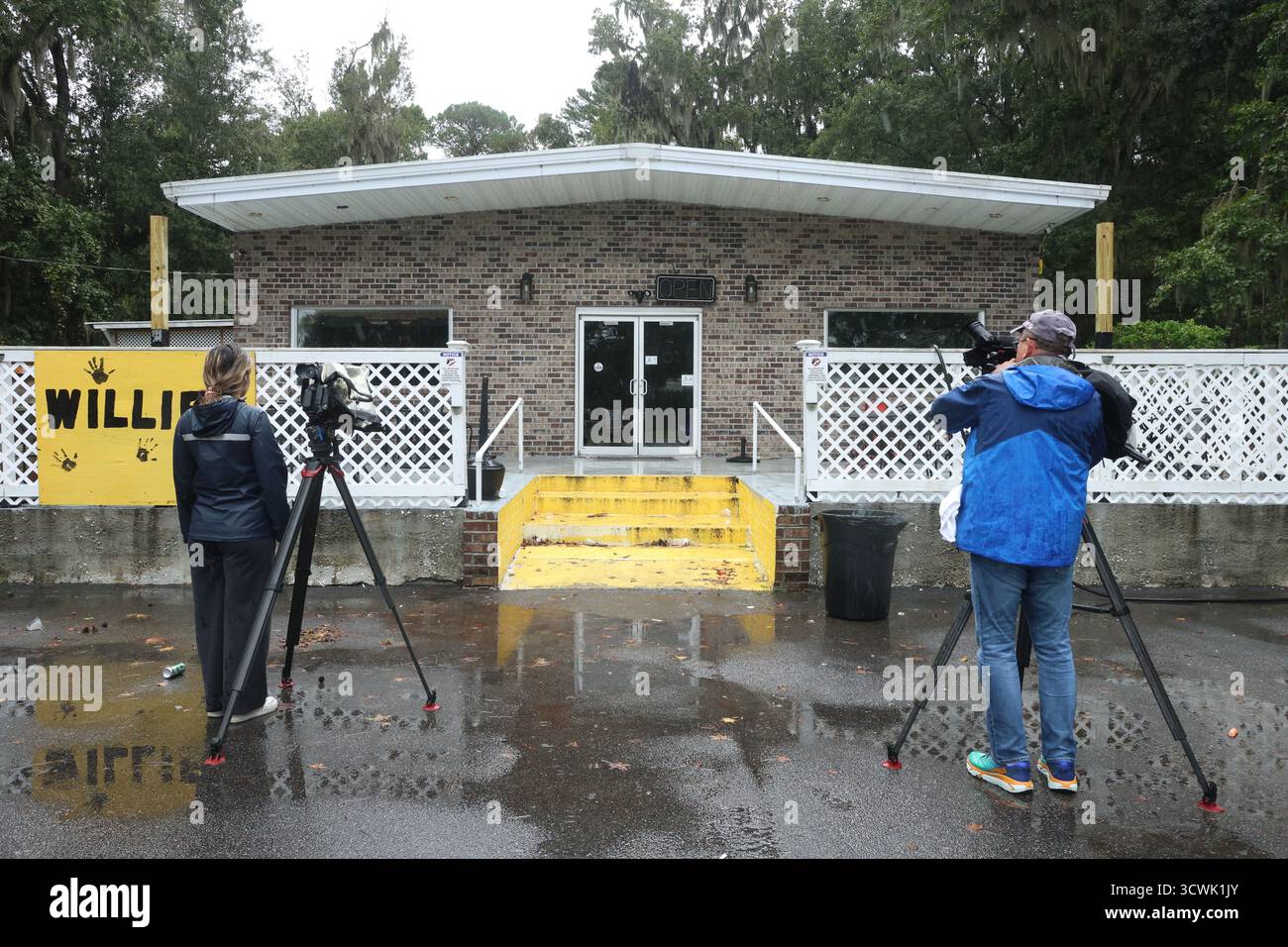 People take video outside of Willie's Bar and Grill in St Helena Island ...