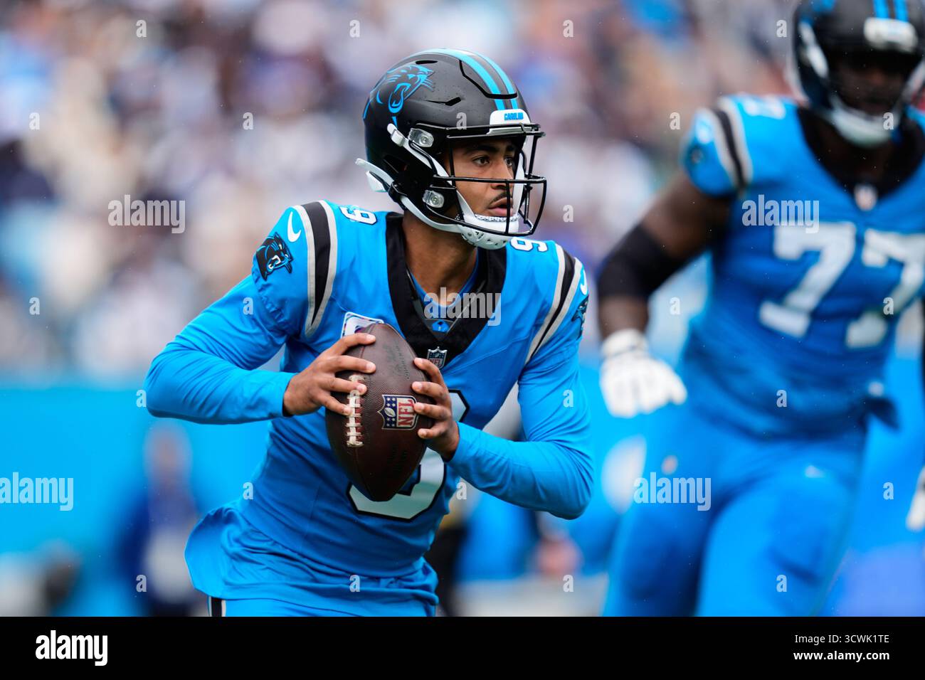 Carolina Panthers quarterback Bryce Young rolls out of the pocket in ...