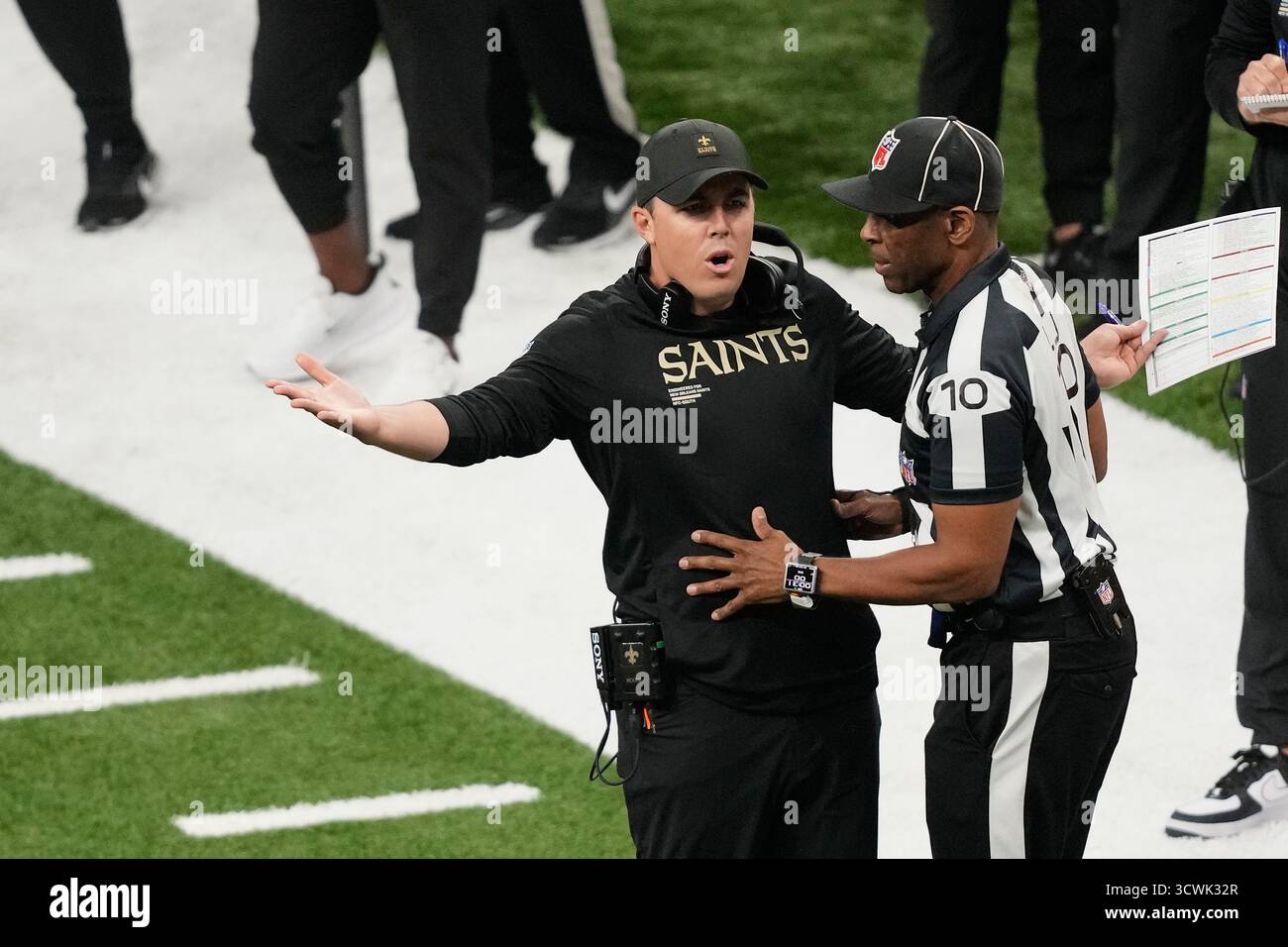 New Orleans Saints head coach Kellen Moore reacts against referee ...
