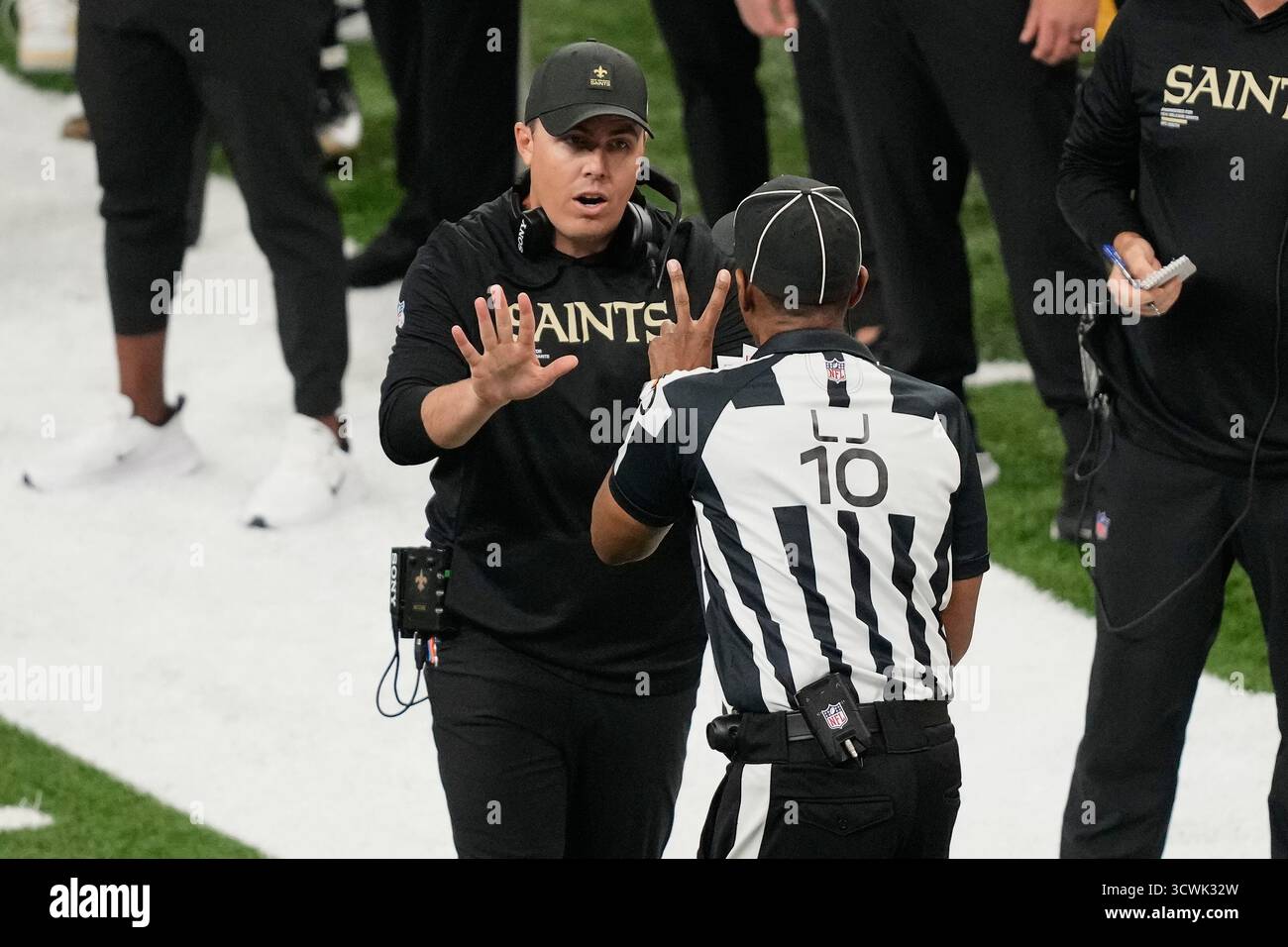 New Orleans Saints head coach Kellen Moore, left, reacts against ...