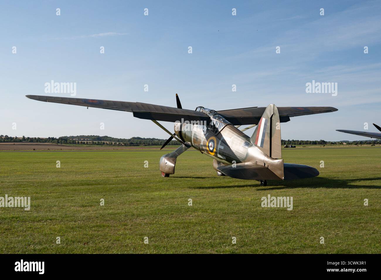 Vintage RAF military aircraft displayed on grass airfield at Duxford ...