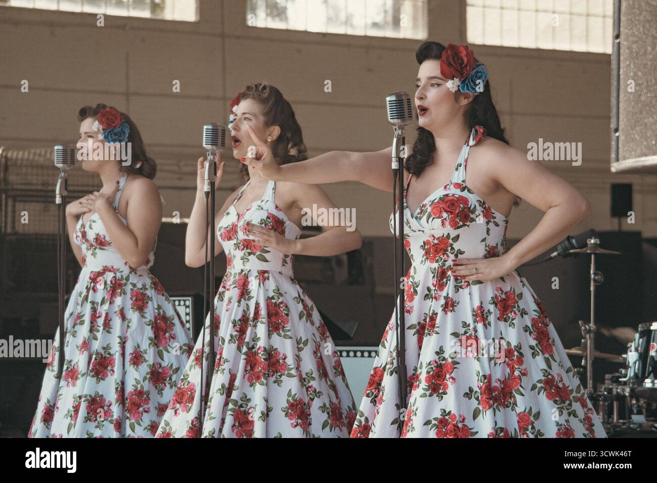 Three vintage-style singers performing at 1940s themed event with ...