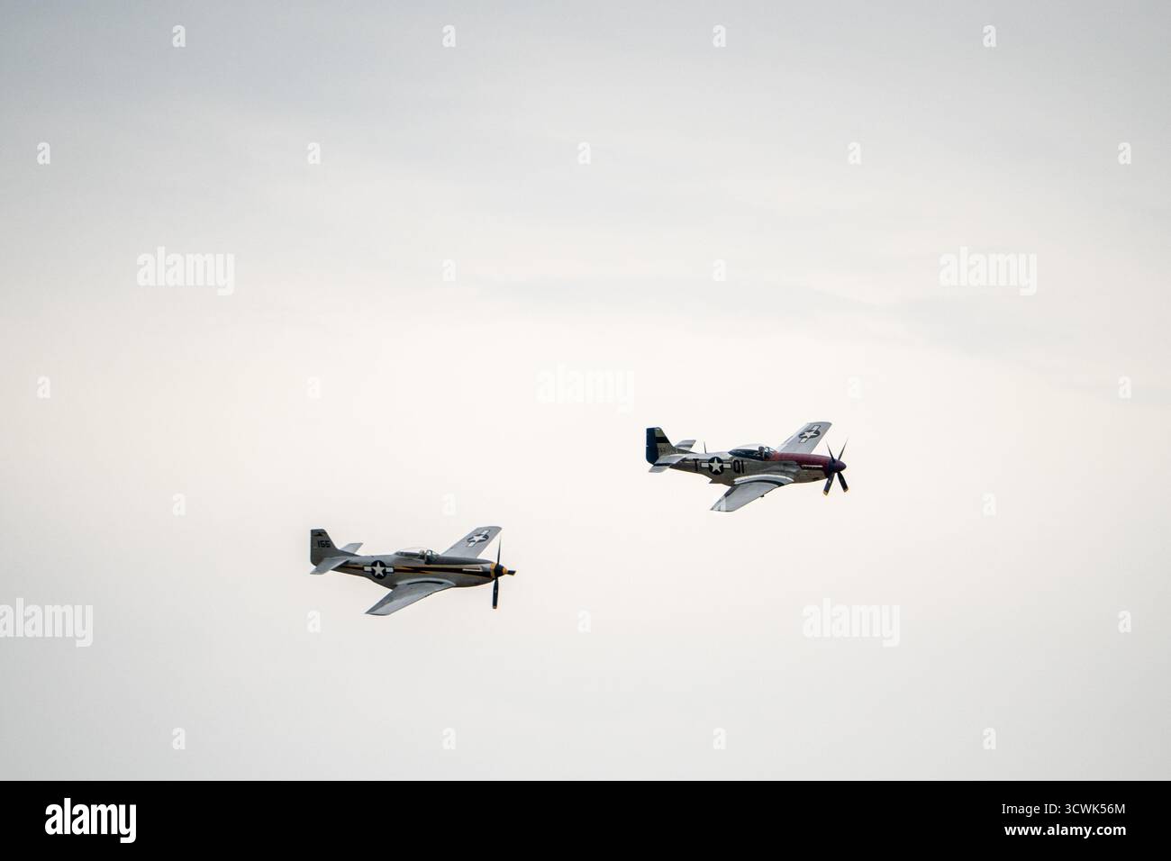 Two North American P-51 Mustang fighter aircraft in formation flight ...