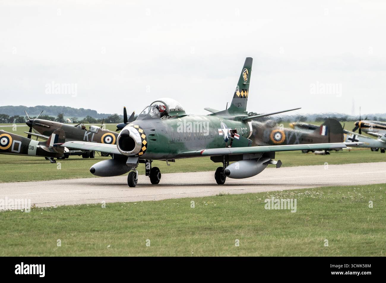 F-86 Sabre jet fighter taxiing on runway at Duxford with Spitfires in ...