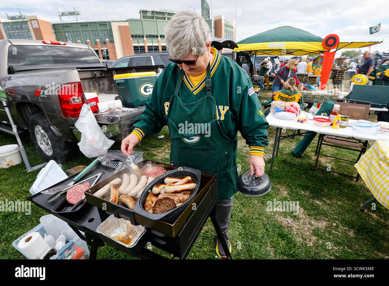 Mary Schroeder, of Morgan, Wis, cooks before an NFL football game ...