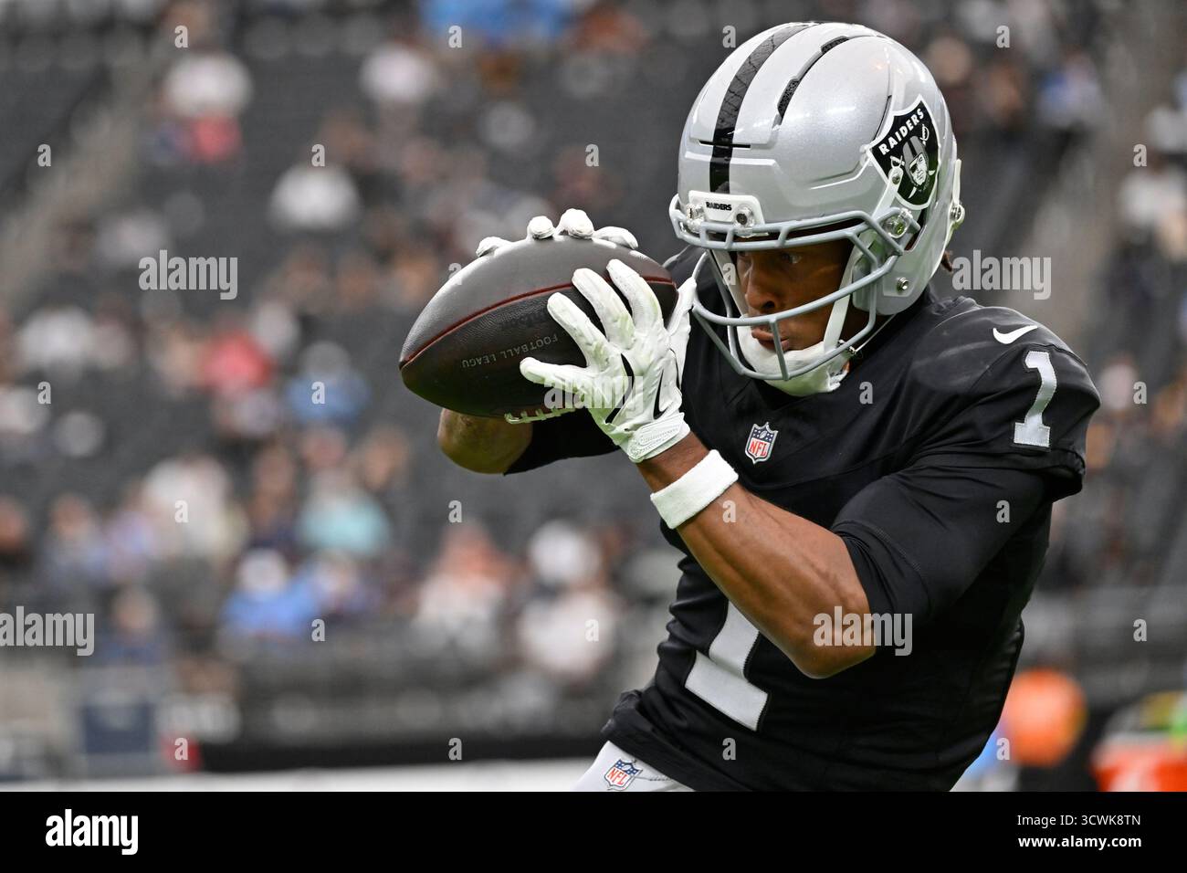 Las Vegas Raiders wide receiver Tre Tucker (1) warms up before an NFL ...
