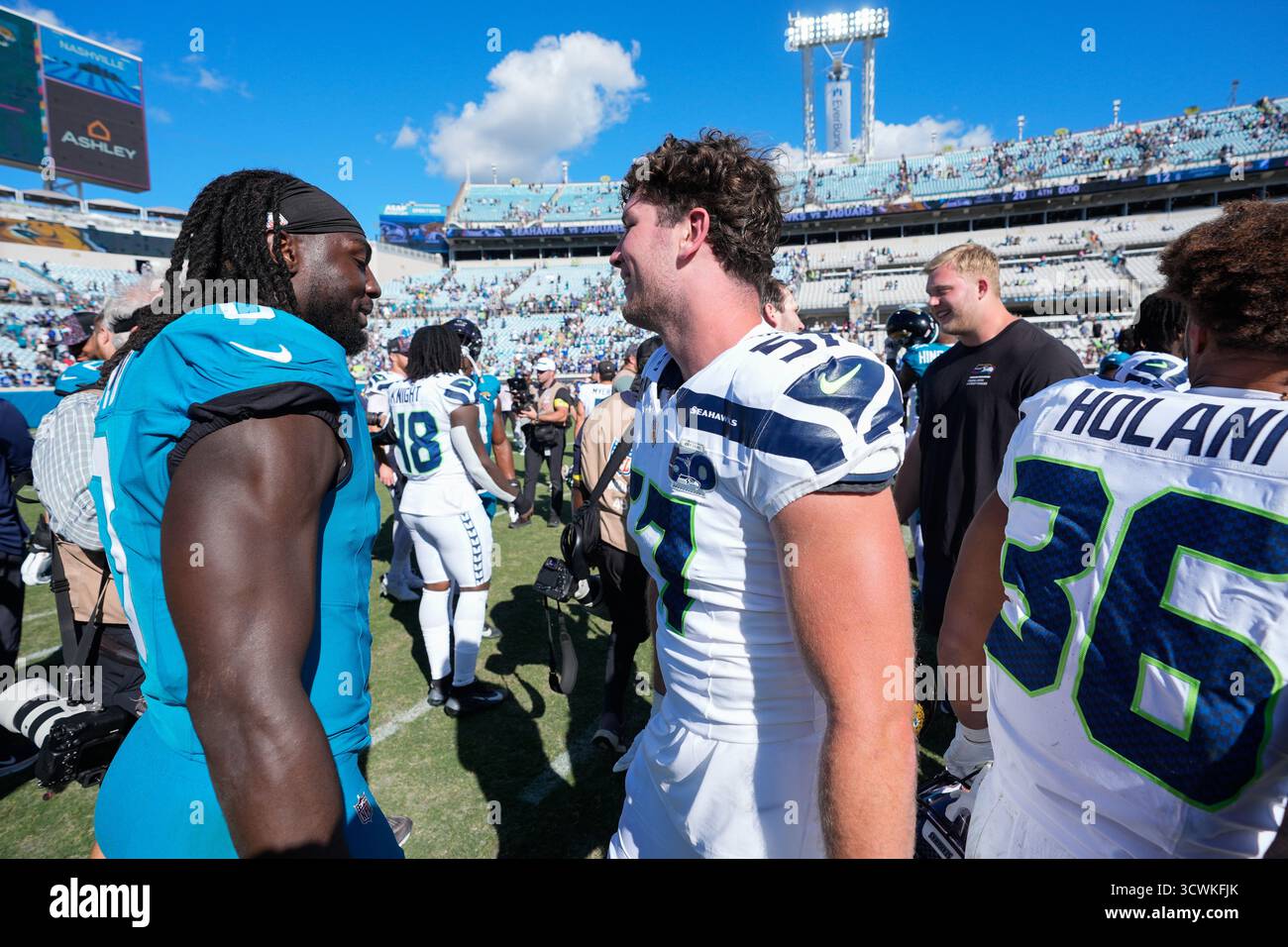 Jacksonville Jaguars linebacker Devin Lloyd (0) greets Seattle Seahawks ...