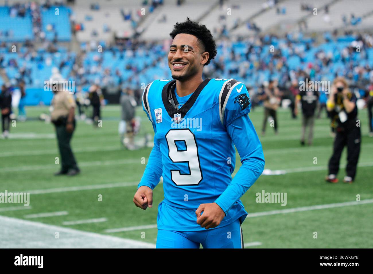 Carolina Panthers' Bryce Young (9) smiles as he jogs off the field ...