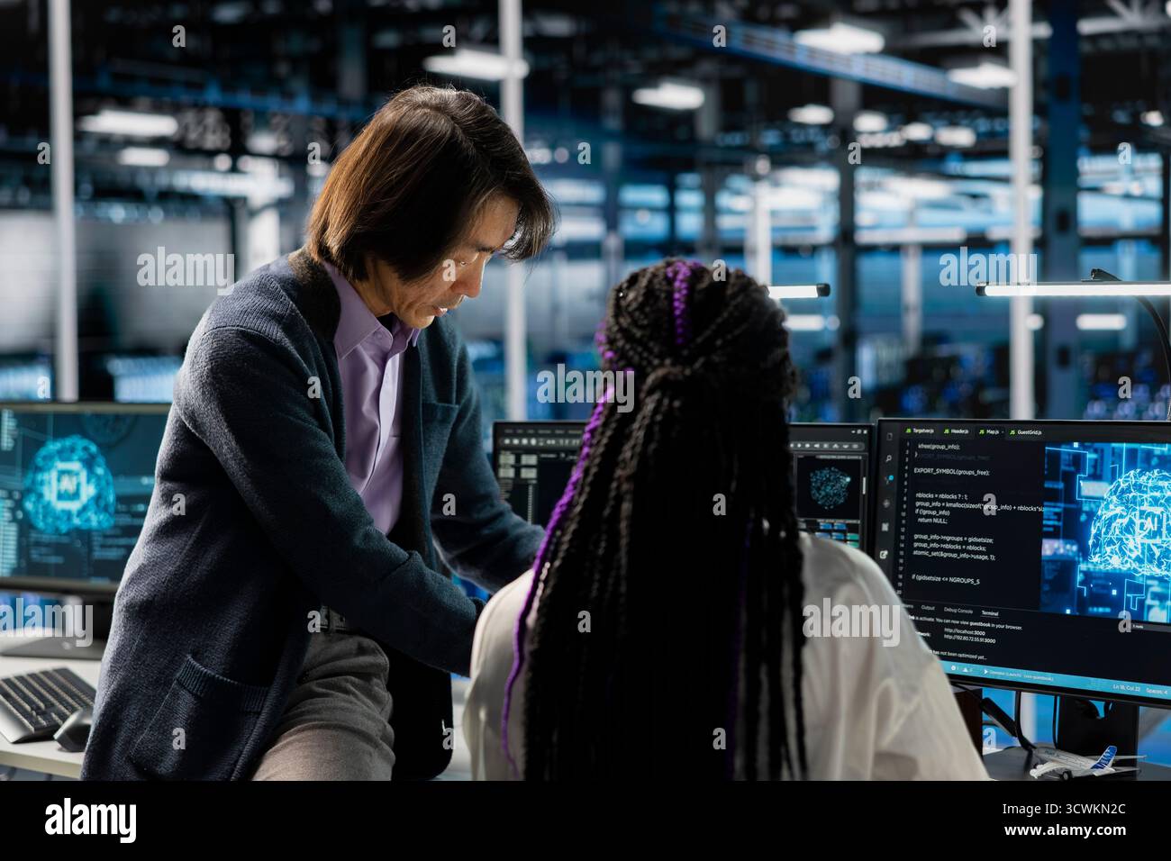 Senior programmer and trainee coding in diverse data center, updating AI automation scripts ...