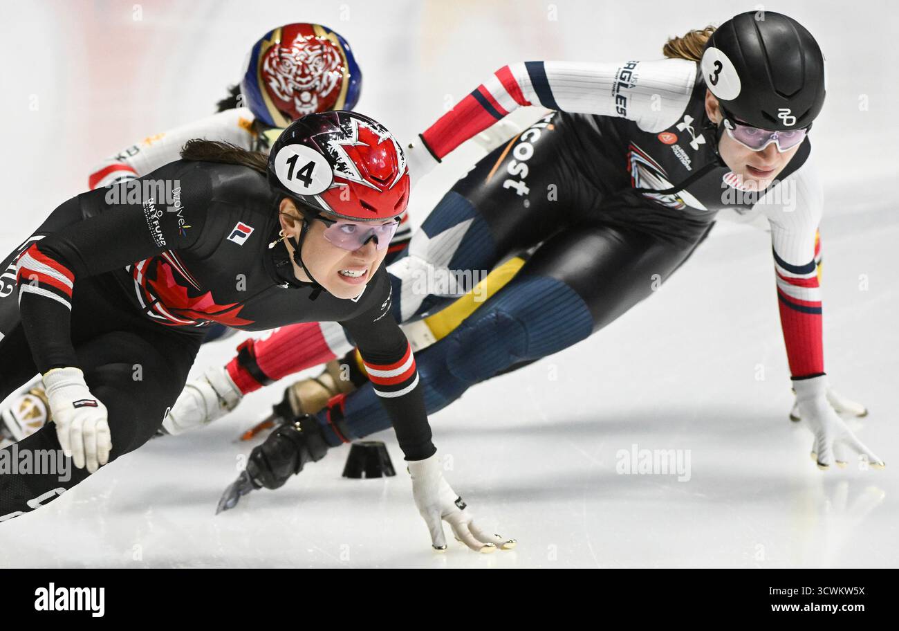 Courtney Sarault (14), of Canada, holds off a challenge from Corinne ...