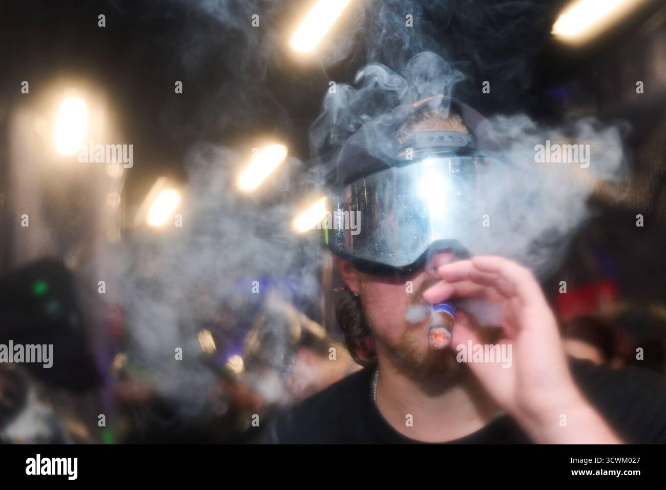 Seattle Mariners relief pitcher Gabe Speier smokes a cigar as he ...