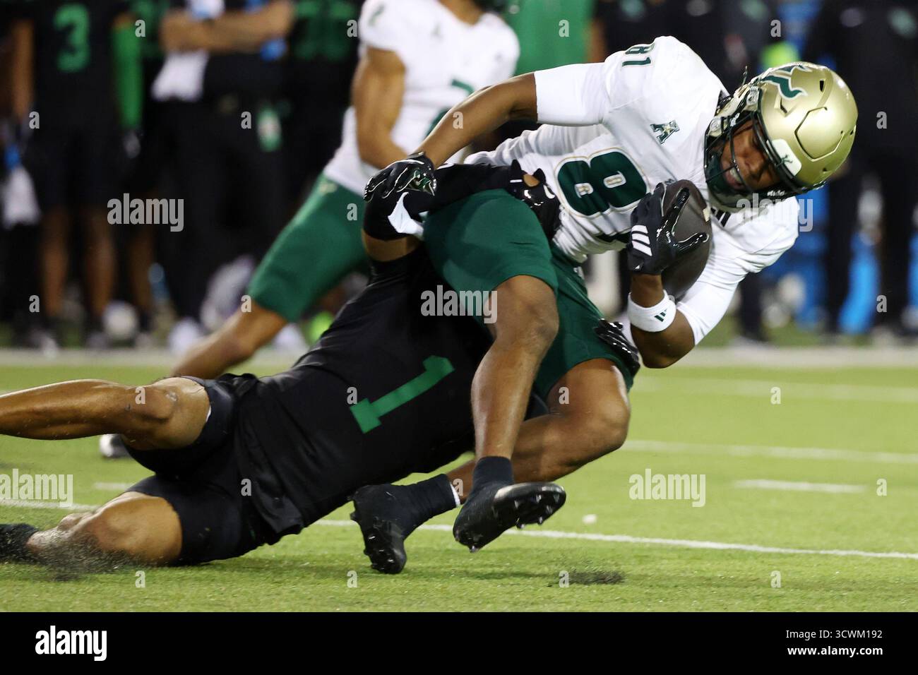 North Texas cornerback David Fisher (1) tackles South Florida wide ...