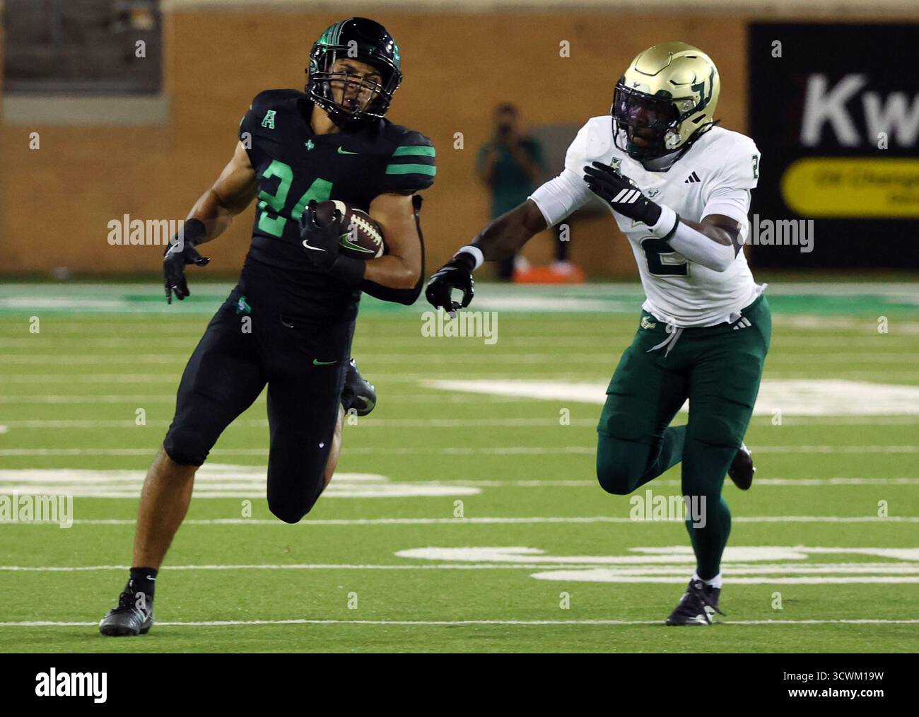 North Texas running back Caleb Hawkins (24) is pursued by South Florida ...