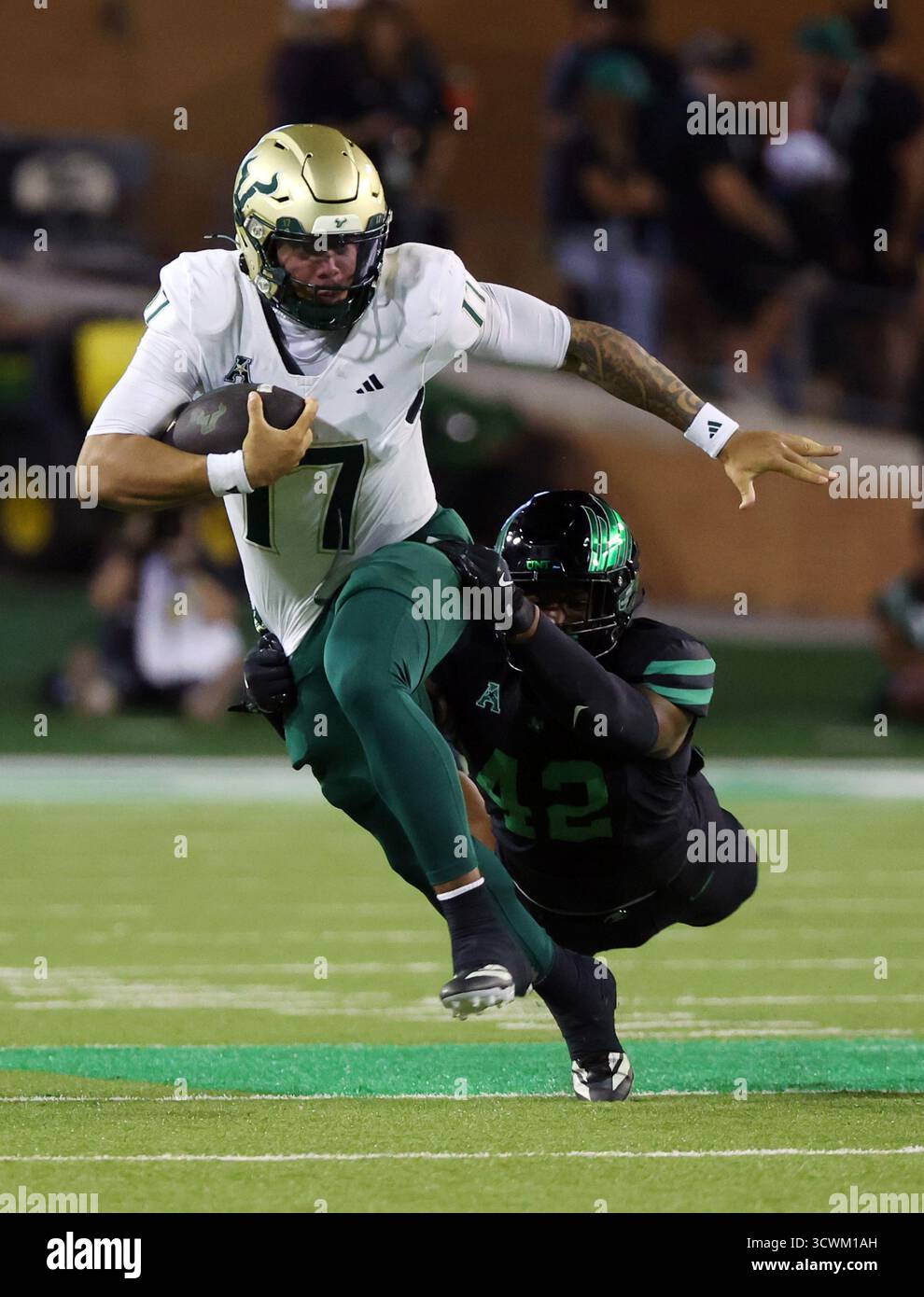 South Florida quarterback Byrum Brown (17) runs the ball as he is ...