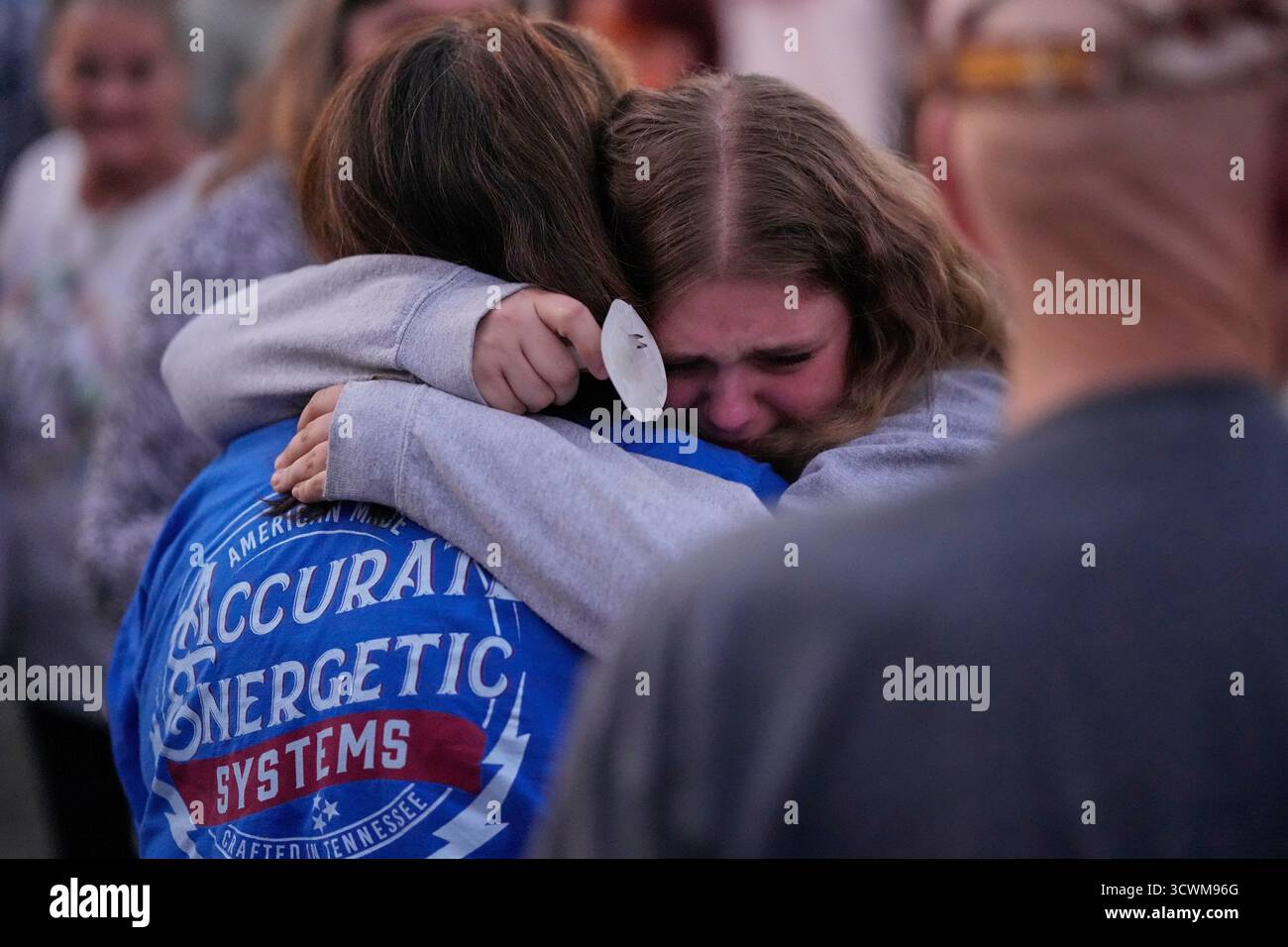People console each other during a candlelight vigil honoring the victims of a blast at an ...