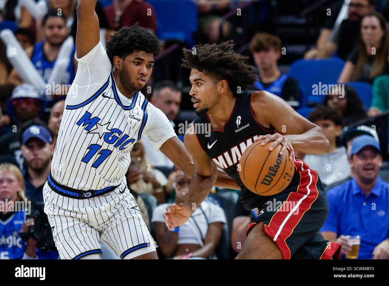 Miami Heat guard Ethan Thompson, right, drives to the basket against ...