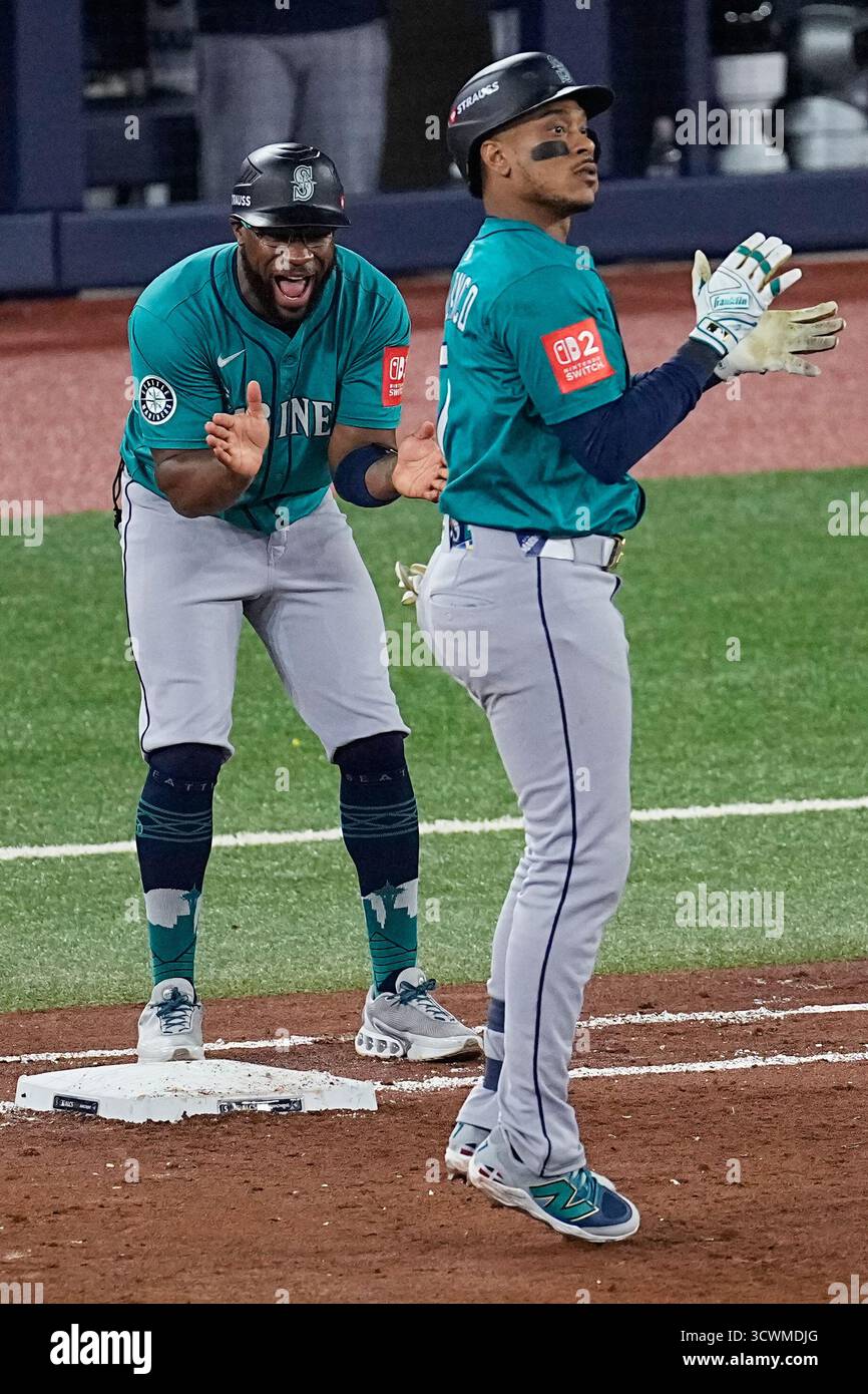 Seattle Mariners' Jorge Polanco, right, celebrates his RBI base hit ...