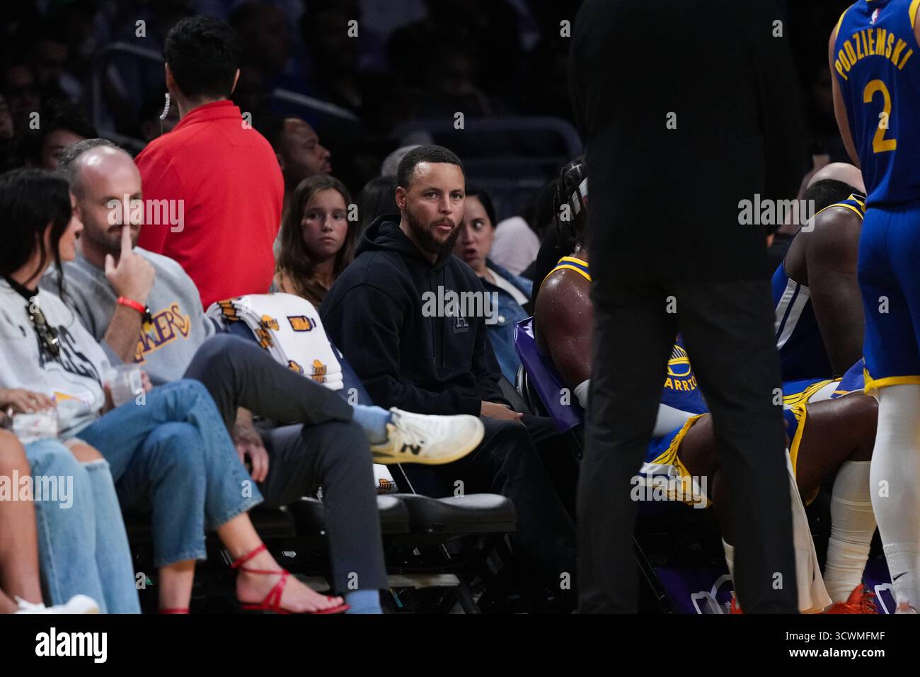 Golden State Warriors' Stephen Curry, center, sits on the bench during ...