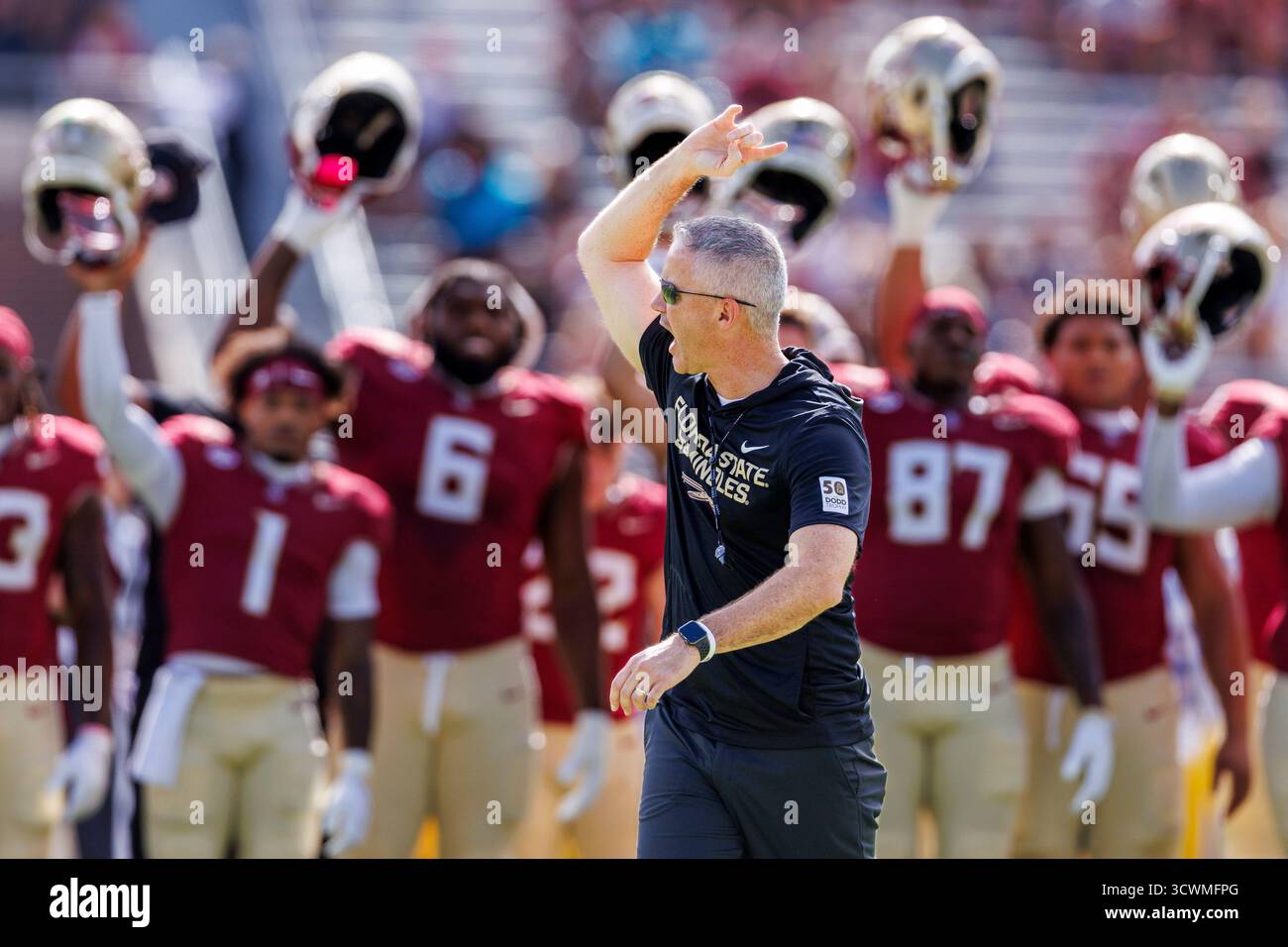 Florida State head coach Mike Norvell leads his team to the locker room ...