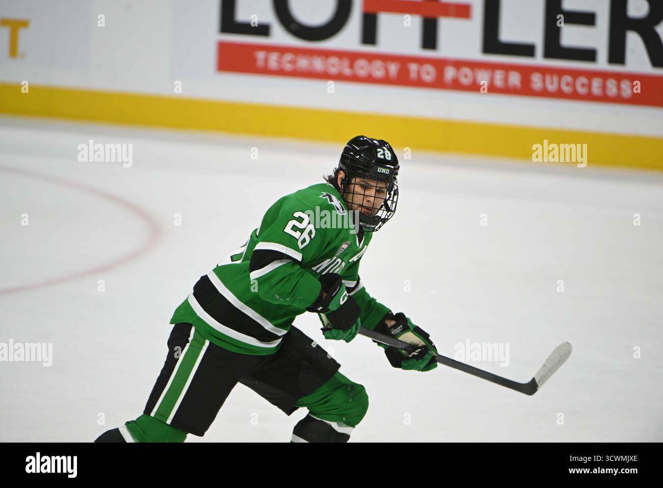 North Dakota forward Dylan James skates to the puck during their game ...