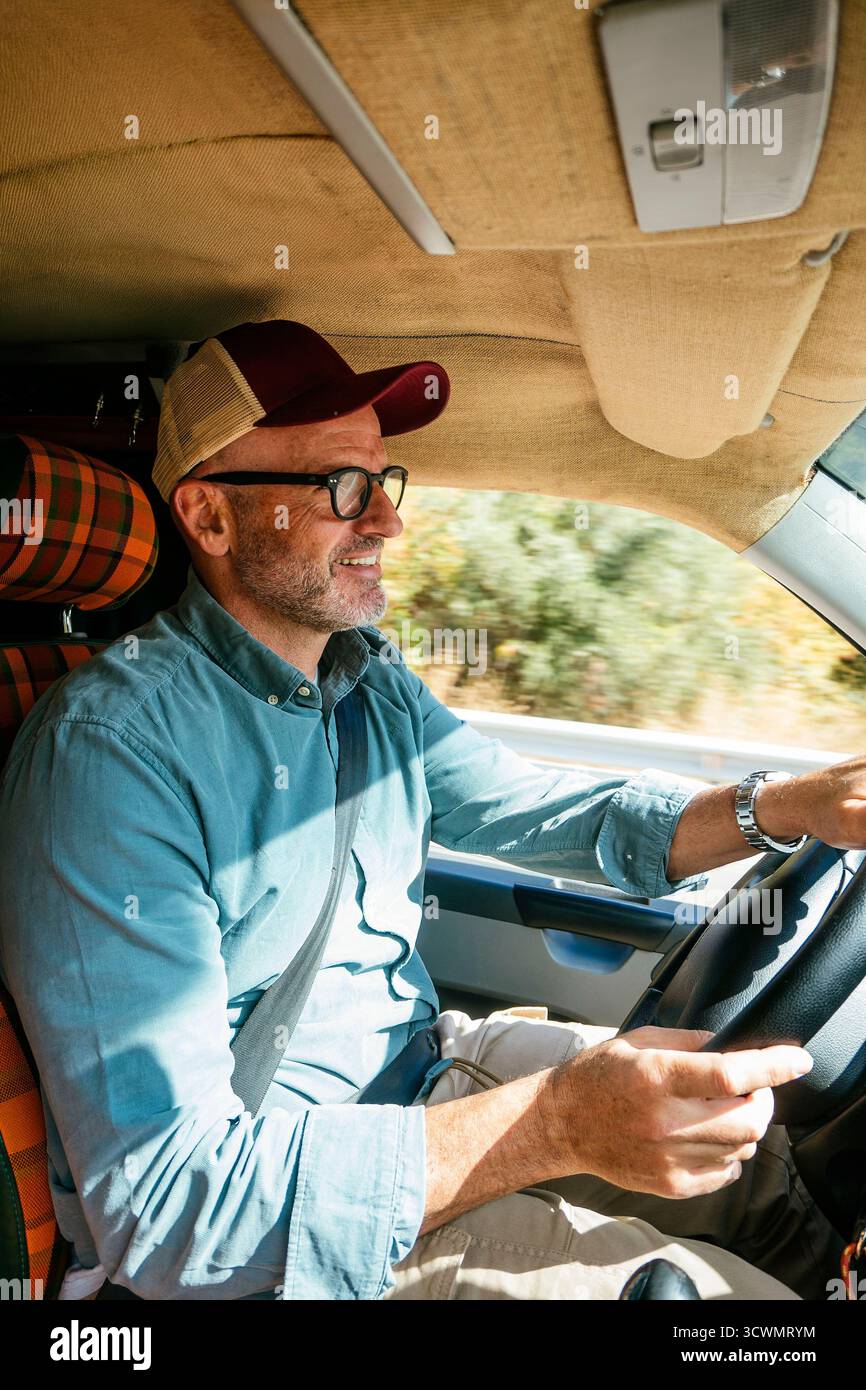 Man driving van on rural road Stock Photo - Alamy