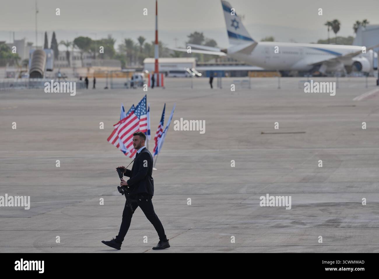 An Israeli security officer patrols the tarmac ahead of a welcoming ...