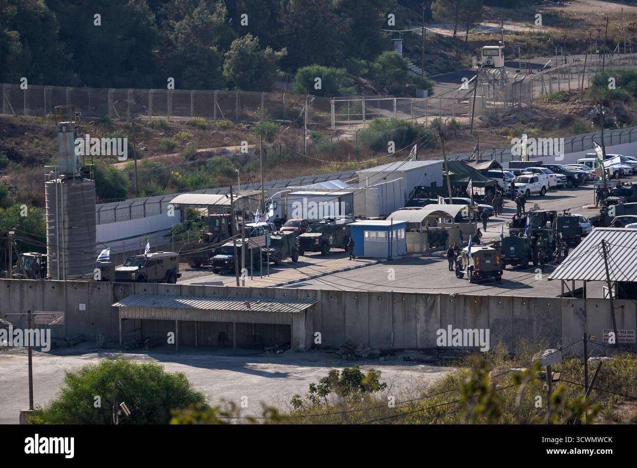 Military vehicles gather at the Israeli Ofer prison in the West Bank ...