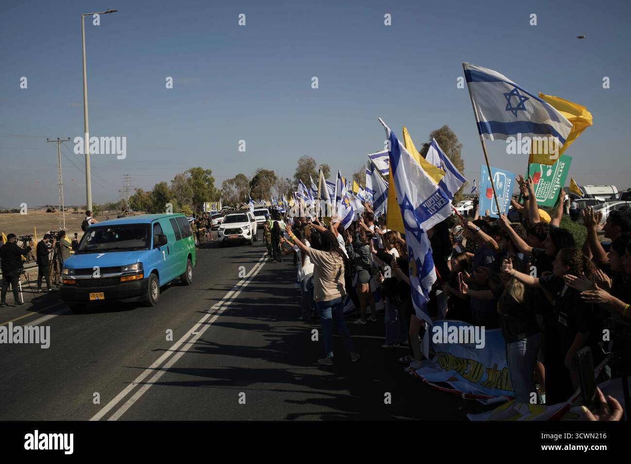 People react as a convoy carrying the hostages released from the Gaza ...