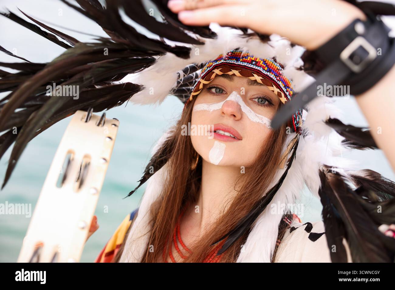 Portrait of beautiful shaman woman in native American Indian headdress ...