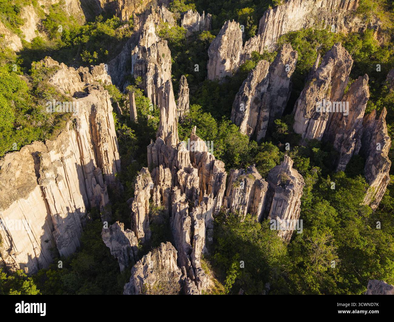 Aerial view of striking rock formations pierce through the verdant ...