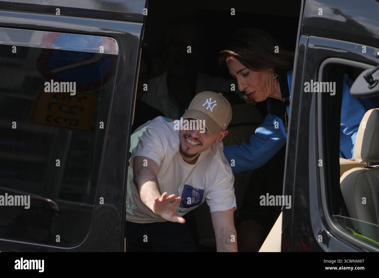 Freed Israeli hostage Eitan Mor gestures from a van as he arrives at ...