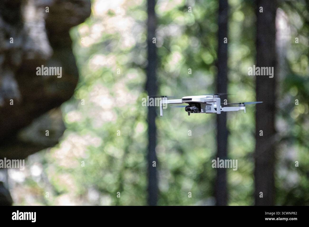 Drone camera flying between trees hi-res stock photography and images ...