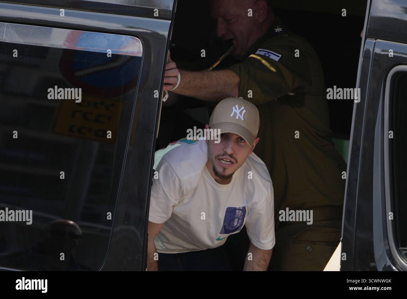 Freed Israeli hostage Eitan Mor appears from a van upon arrival at ...