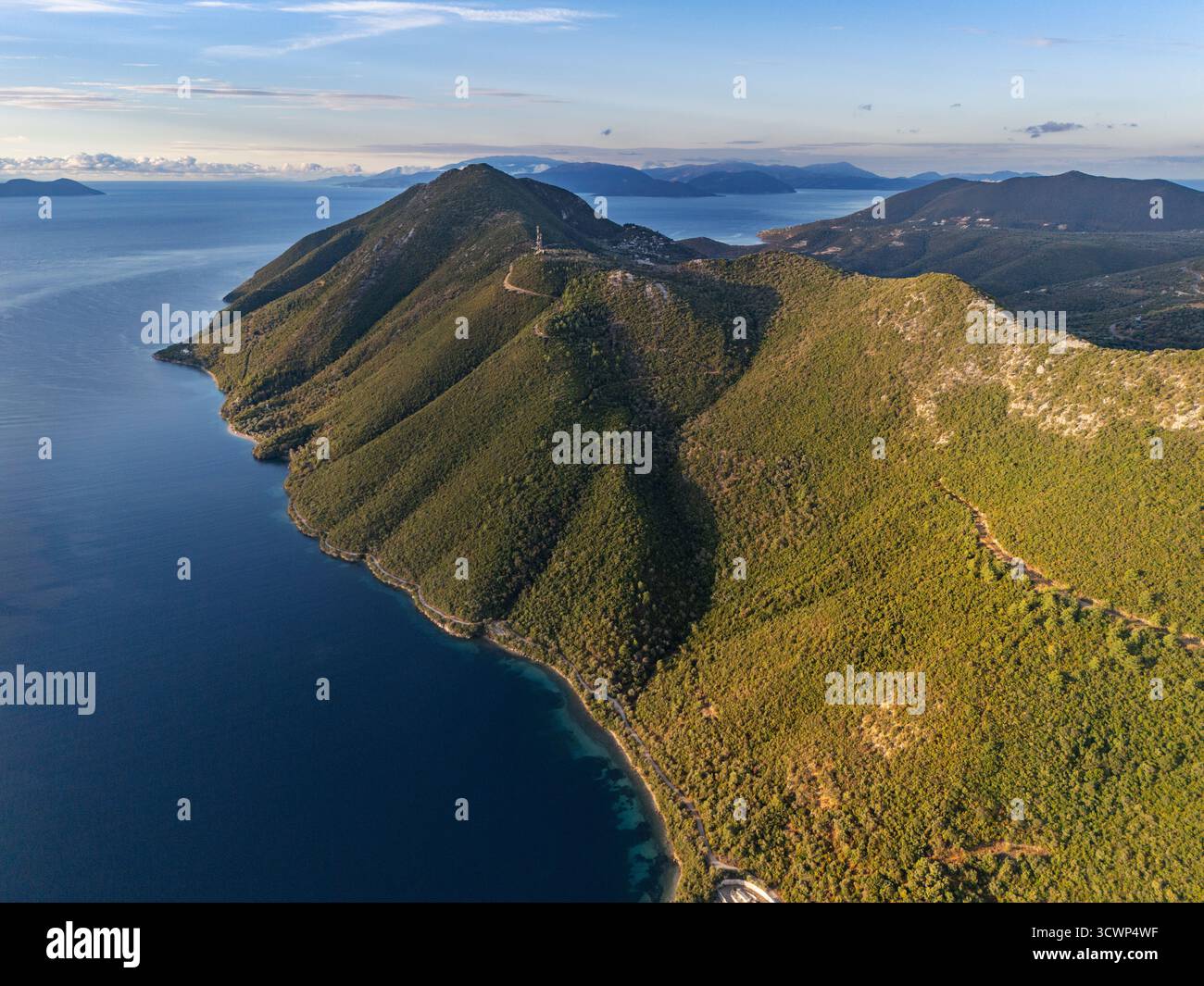 Aerial view of the rugged coastline where the emerald green hills meet ...