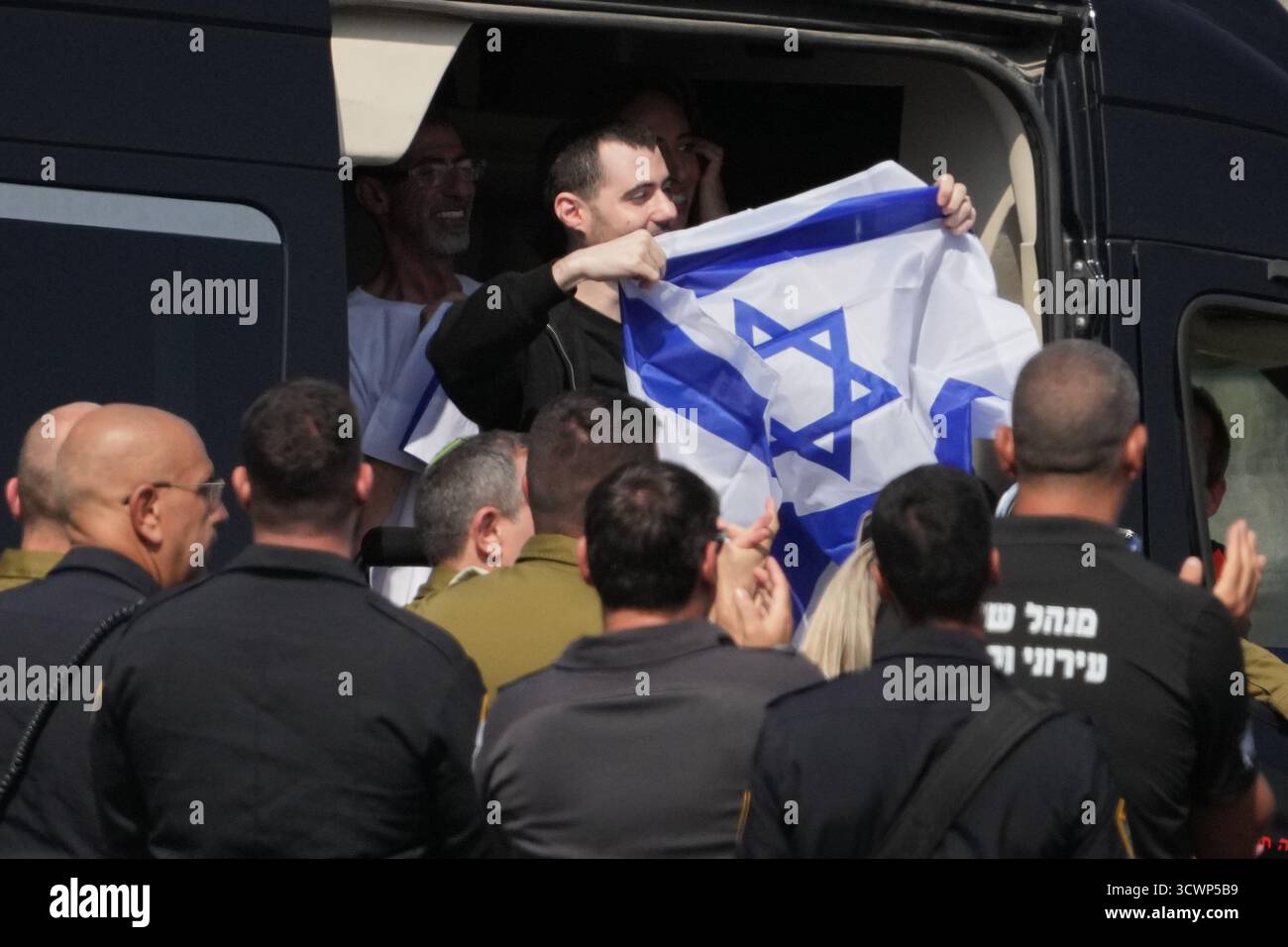 Freed Israeli hostage Guy Gilboa-Dalal waves an Israeli flag as he ...