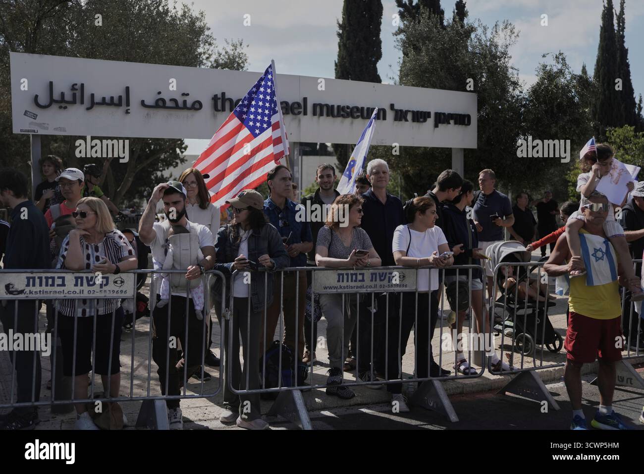 People with U.S. and Israeli flags stand near the Knesset, Israel's ...