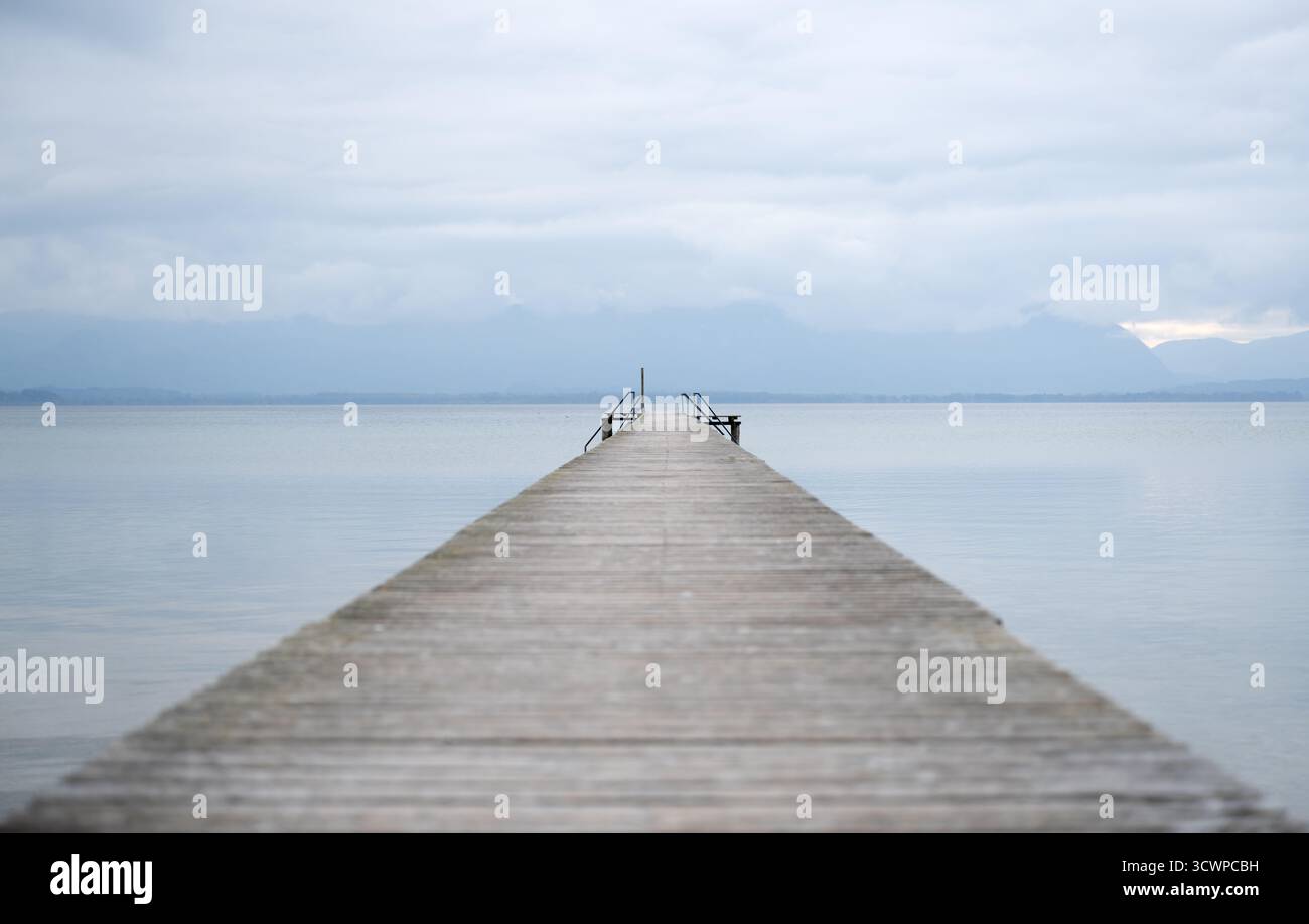 13 October 2025, Bavaria, Seebruck: A jetty juts out into the Chiemsee ...