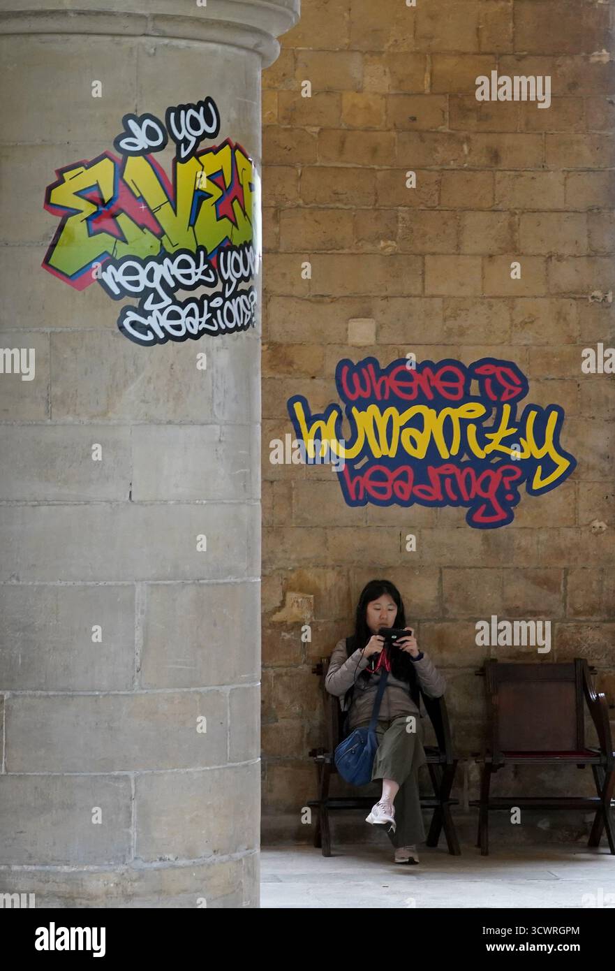 A visitor views graffiti artwork from the 'Hear Us' installation, a ...