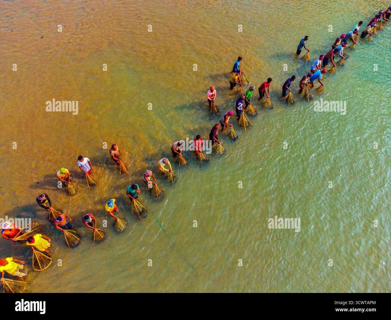 Polo, Bangladesh - 13 December 2023: Aerial view of fishermen wading ...